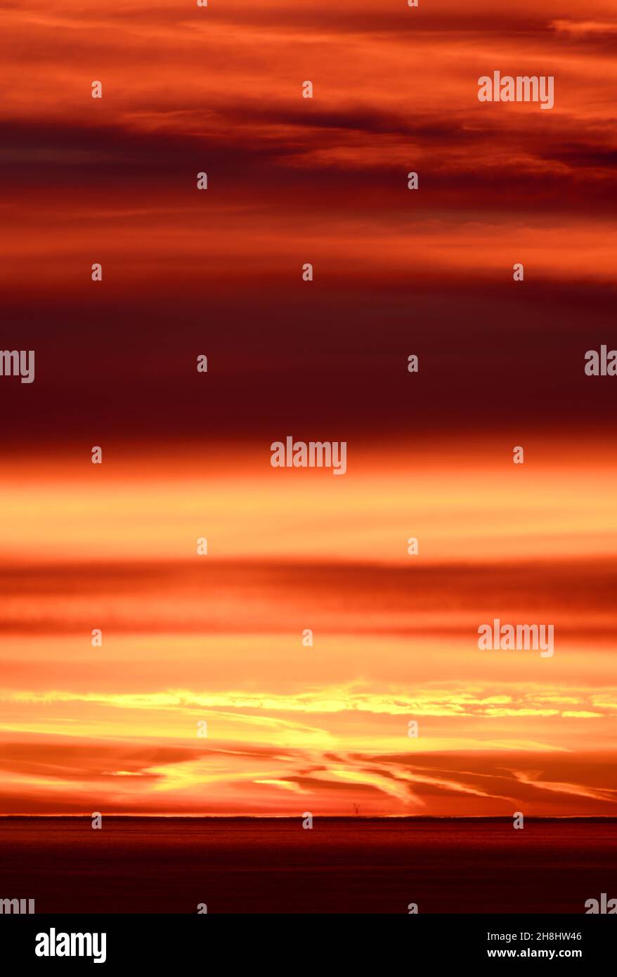 Sunrise looking east from Mumbles head, over the sea to distant horizon ...