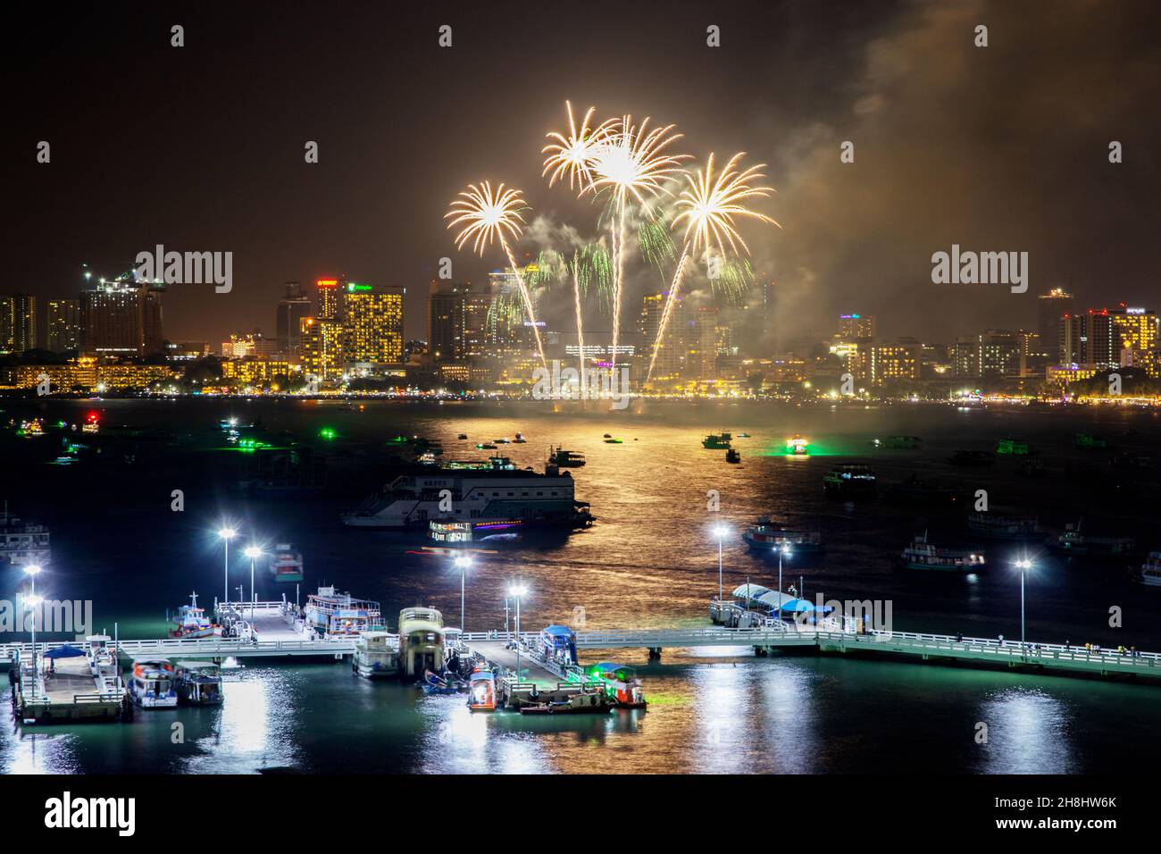 colorful fireworks display over the night sky of the city during a ...