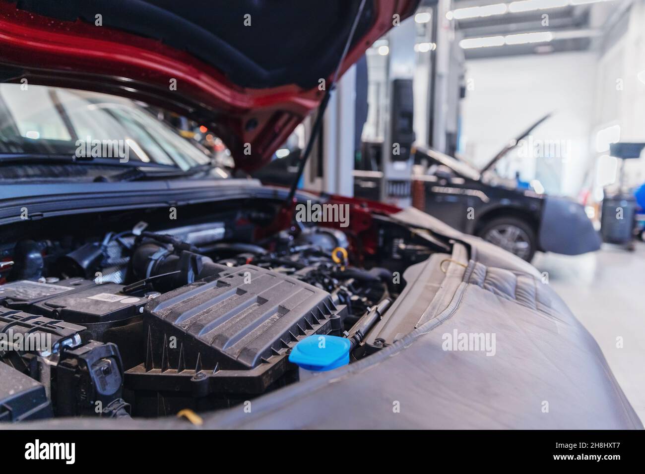 Open hood and disassembled engine in car service, maintenance and oil ...