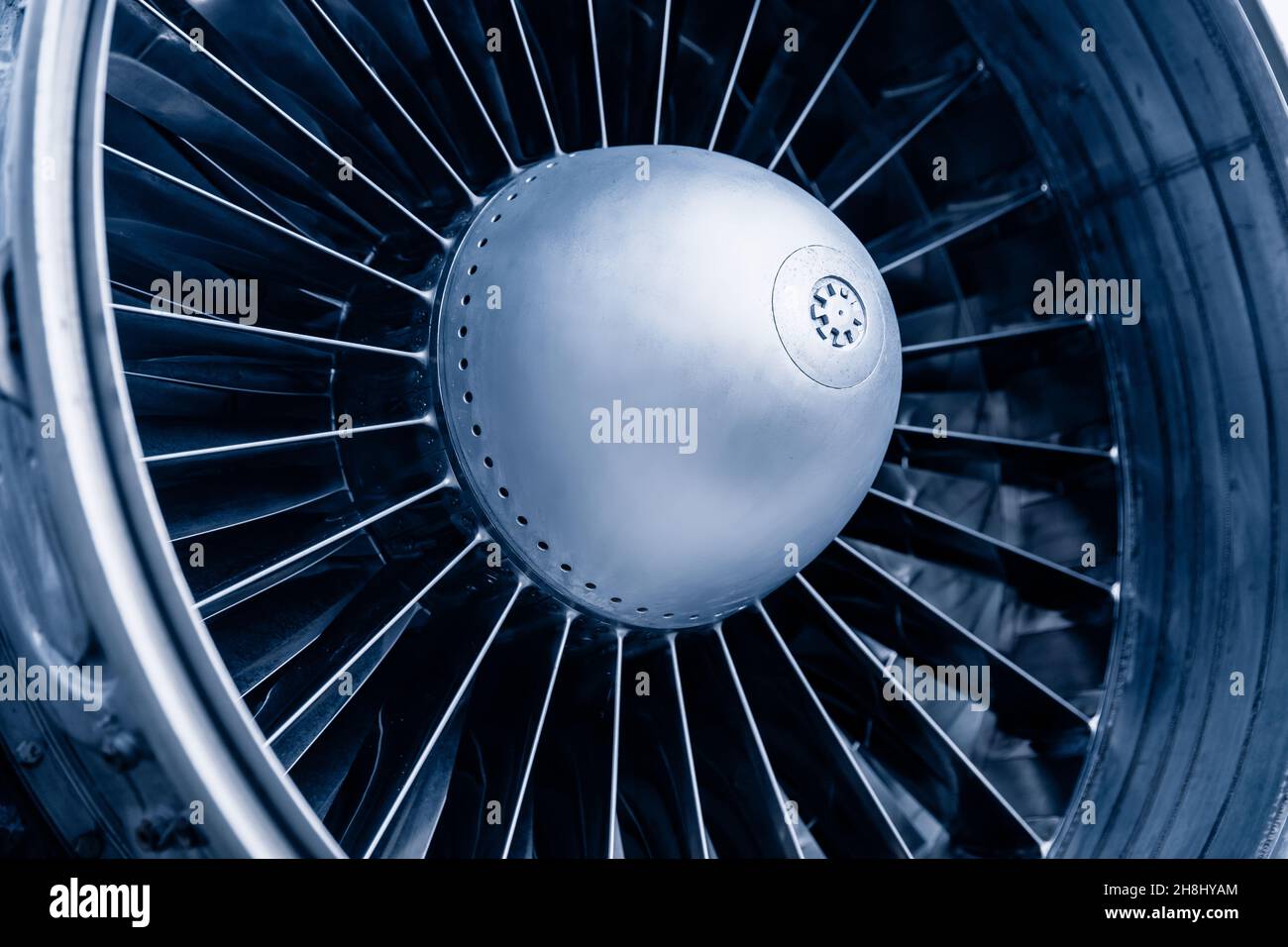 Closeup detail of turbine airplane engine blades, toning blue color ...