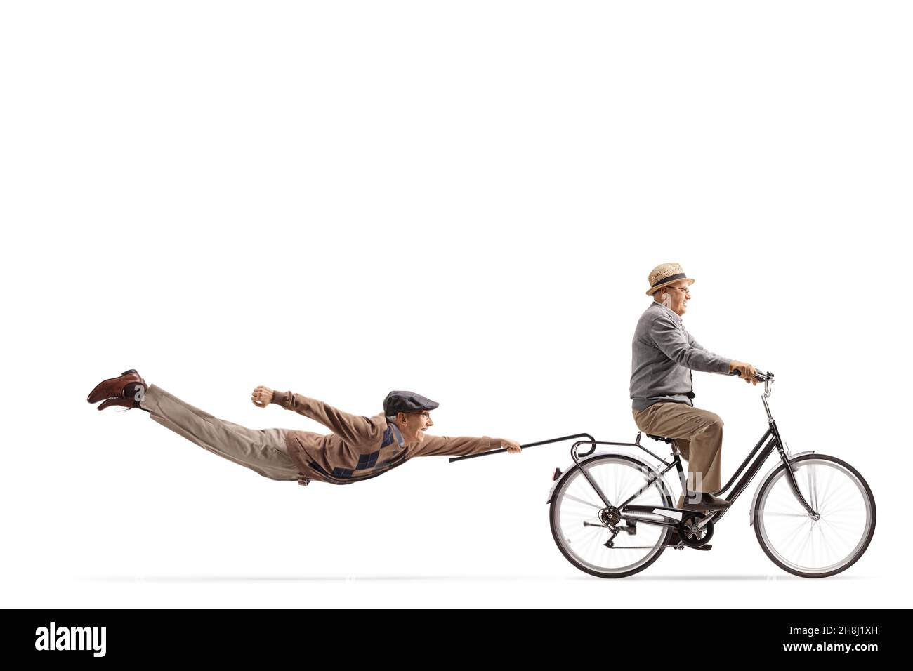 Elderly man riding a bicycle and other man flying behind isolated on ...