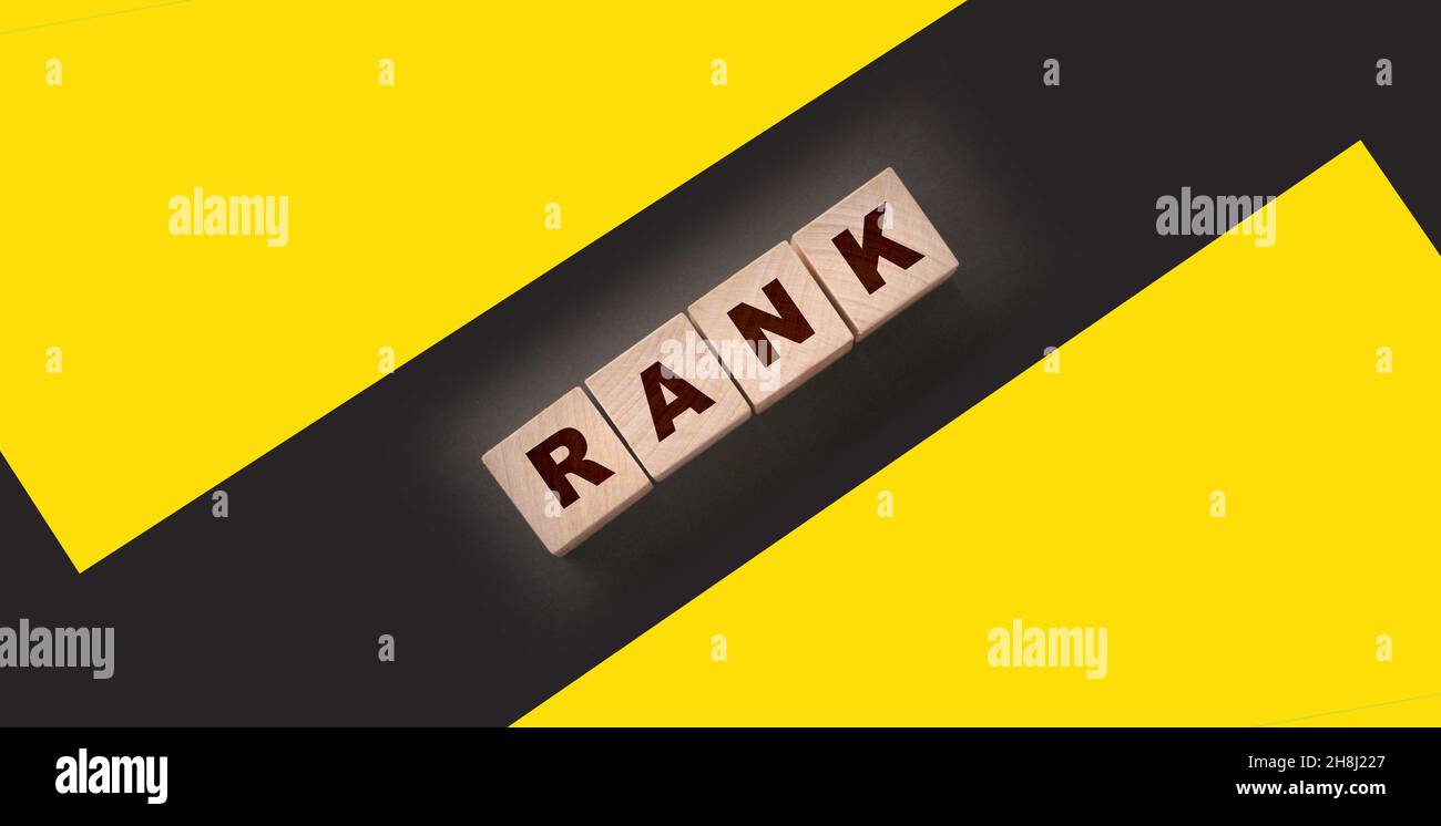 RANK text on a black background on wooden cubes. Ranking SEO concept ...