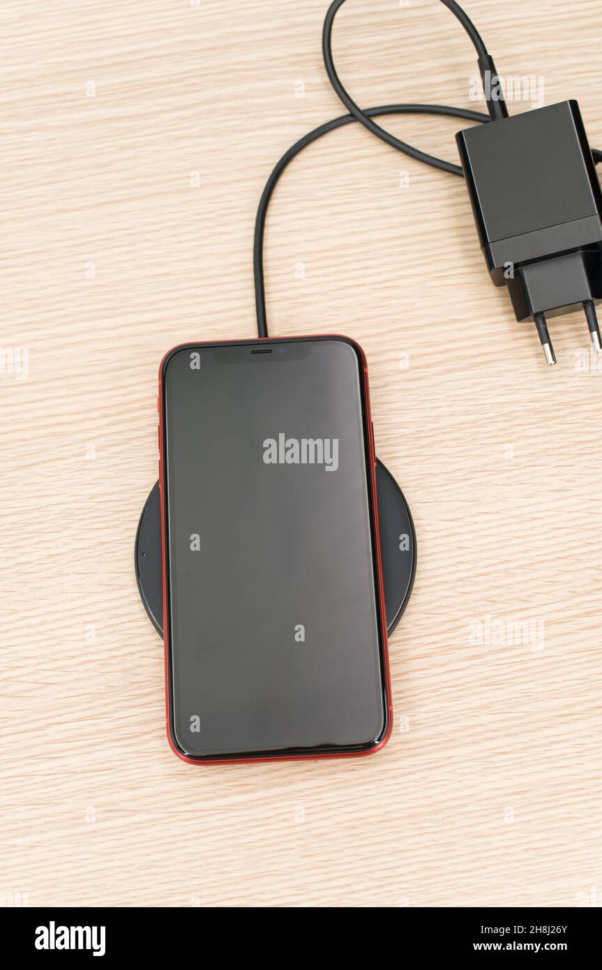 INVERIGO, ITALY - Nov 29, 2021: wireless induction device charger with ...