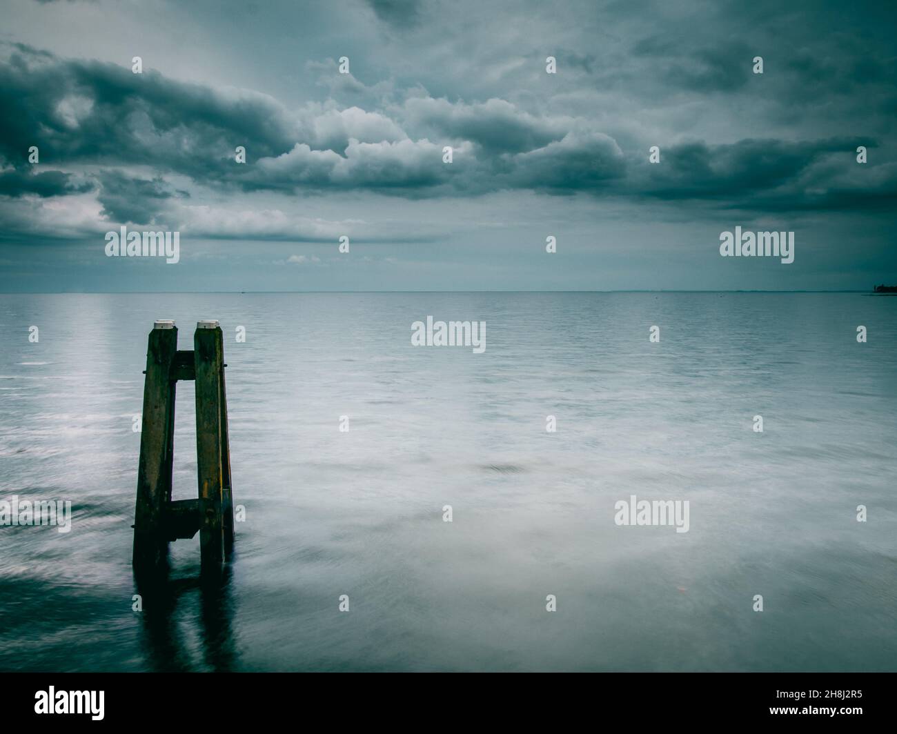 Calm night sea and pillar Stock Photo - Alamy