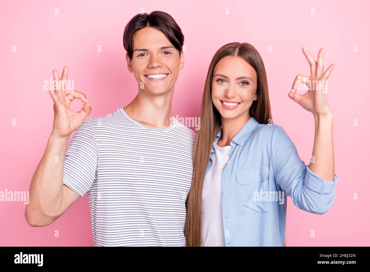 Photo of pretty shiny young lovers dressed casual outfits showing okey ...