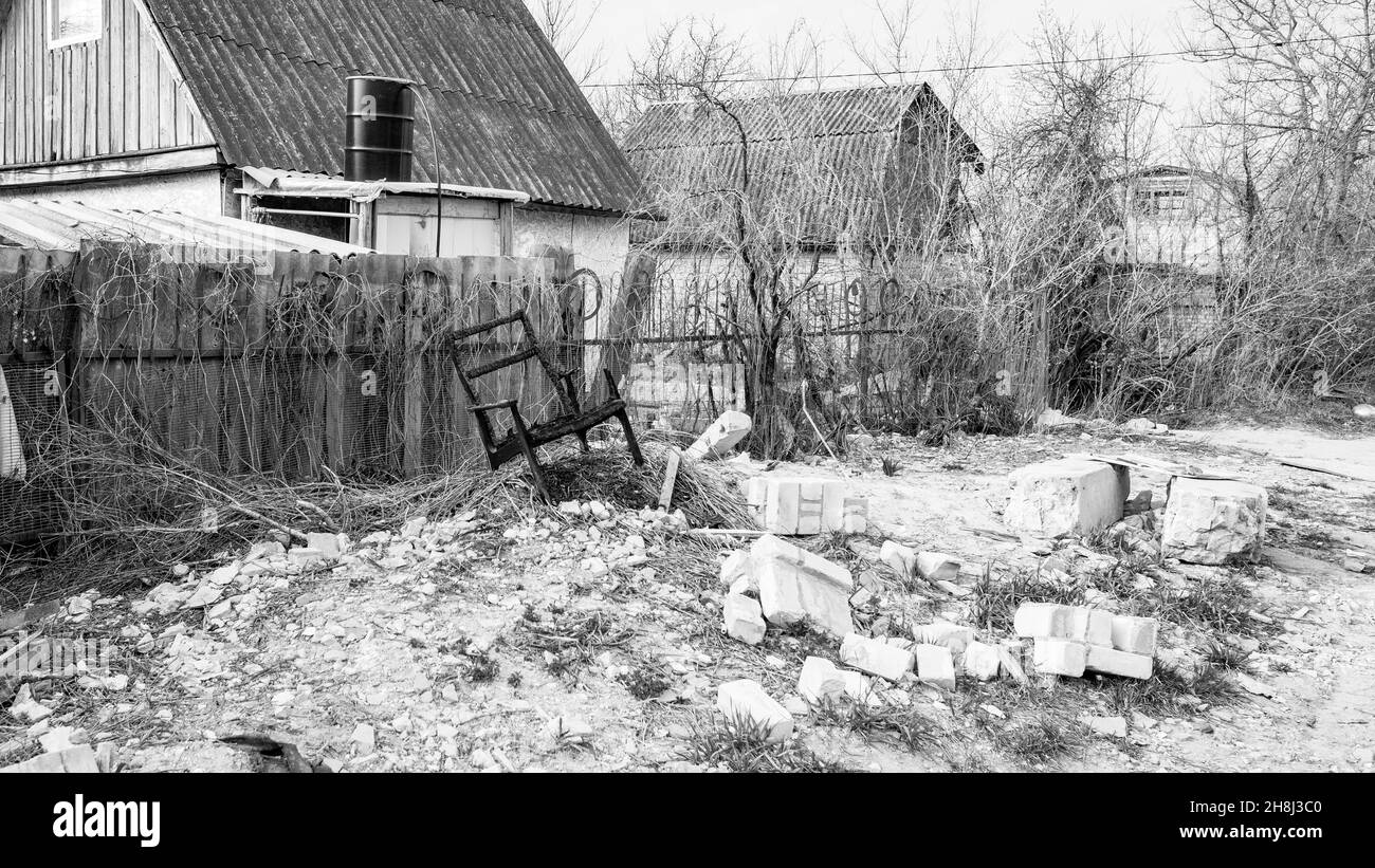 Burnt chair, similar to the throne, standing on a pile of construction ...