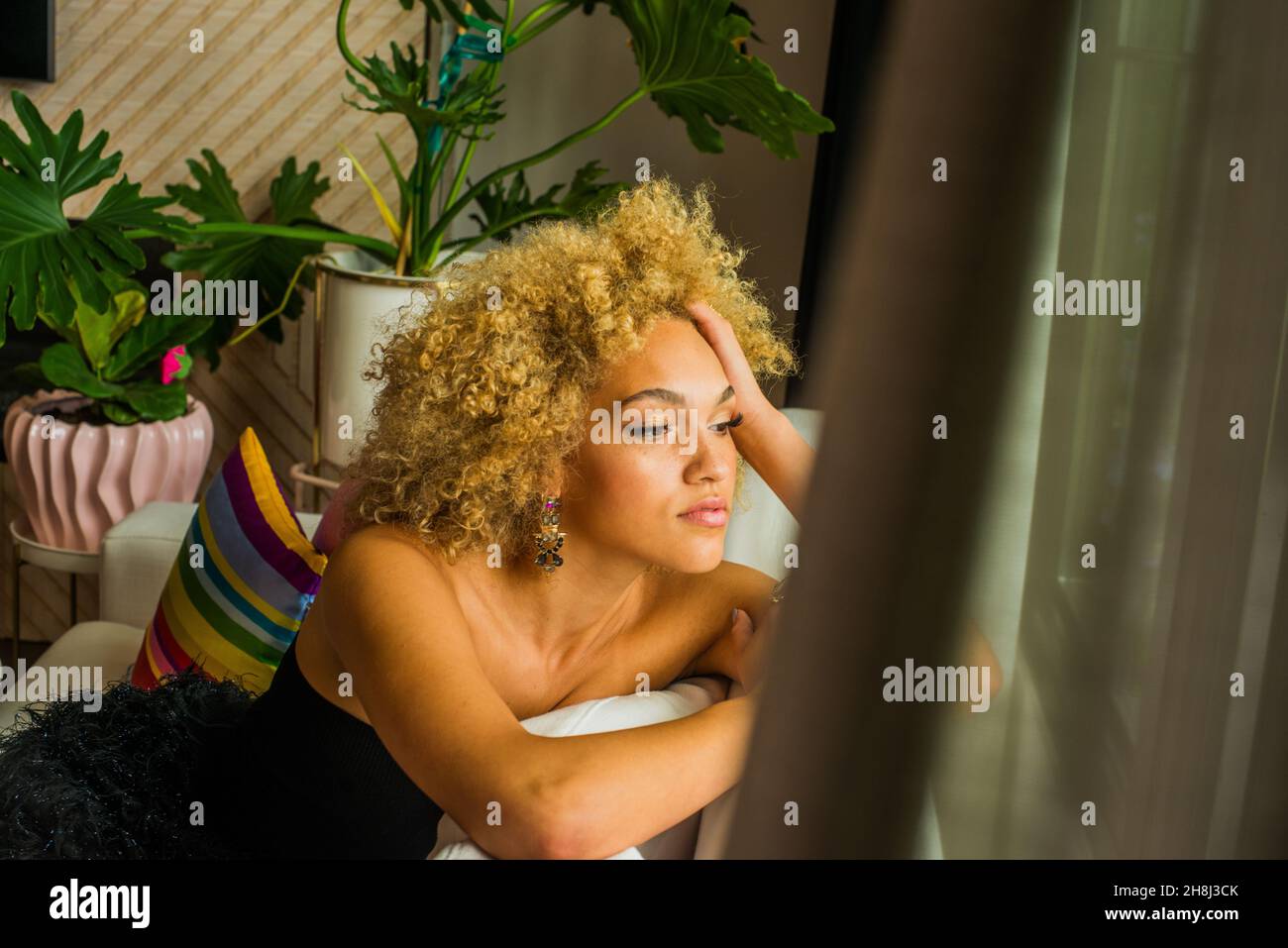 Relaxing & thinking by the window Stock Photo - Alamy