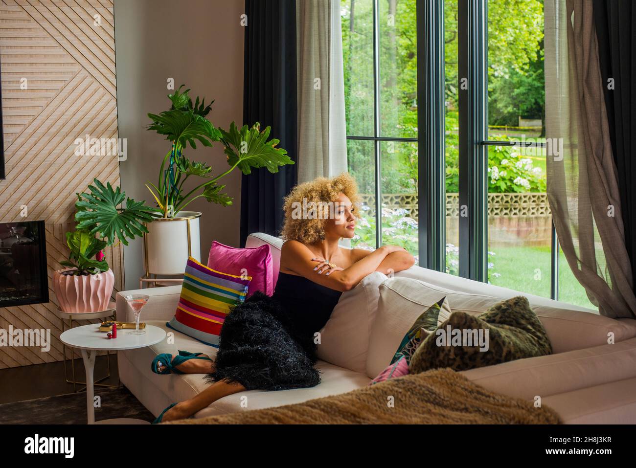 Relaxing and waiting by the window Stock Photo - Alamy