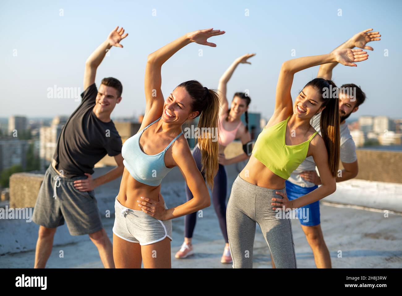 Group of fit healthy friend, people exercising together outdoor Stock ...