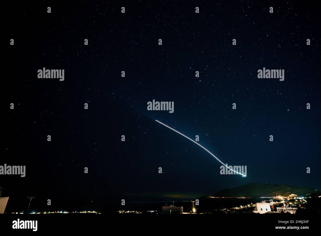 airplane track in the night sky Stock Photo - Alamy
