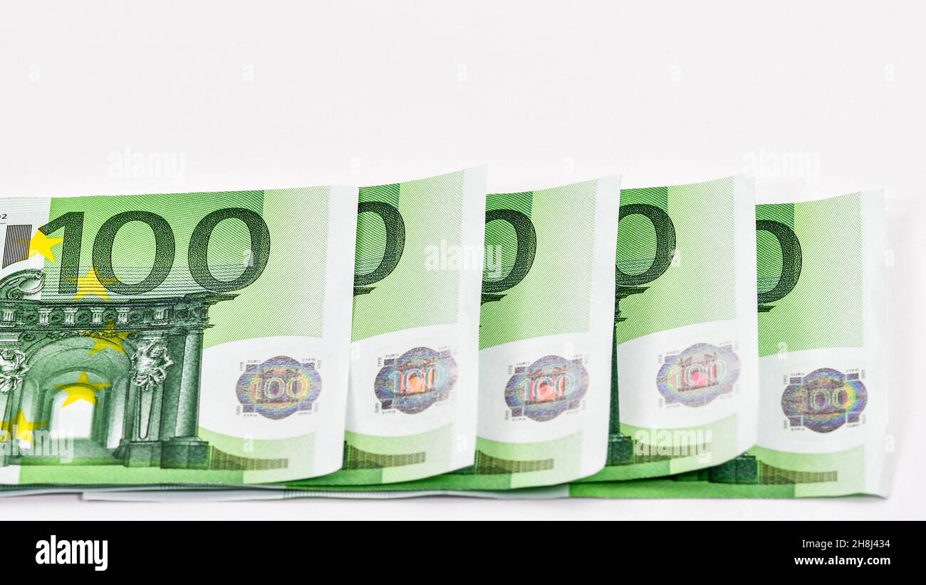 Closeup shot of a 100 euro banknote detail isolated on white background ...