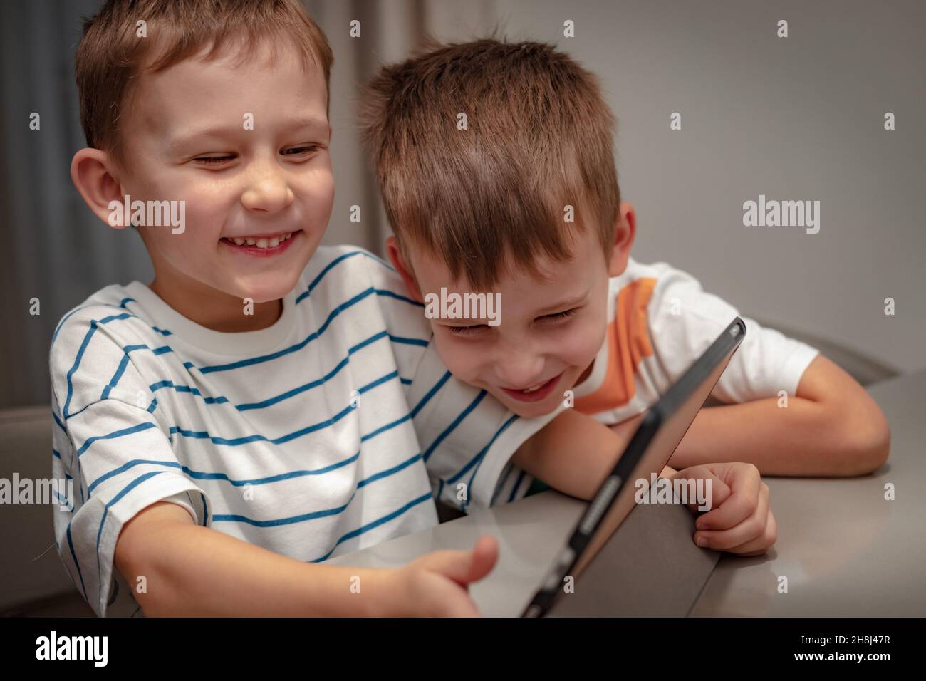 two boys play computer games at home Stock Photo - Alamy