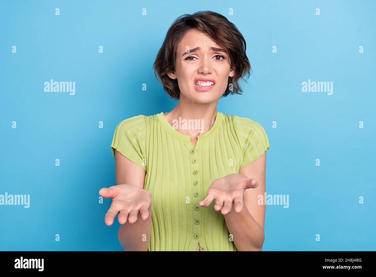 Photo of confused unsure young woman dressed green t-shirt pointing you ...