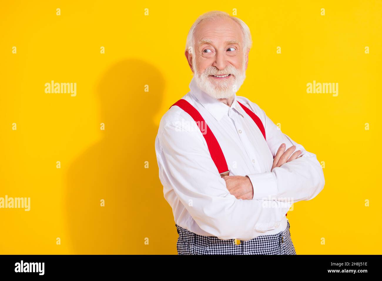 Photo of impressed old white hair man crossed arms look empty space wear white shirt suspenders ...