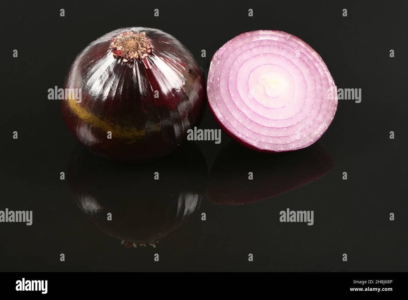 Red onion bulb isolated on acrylic black background. High resolution ...