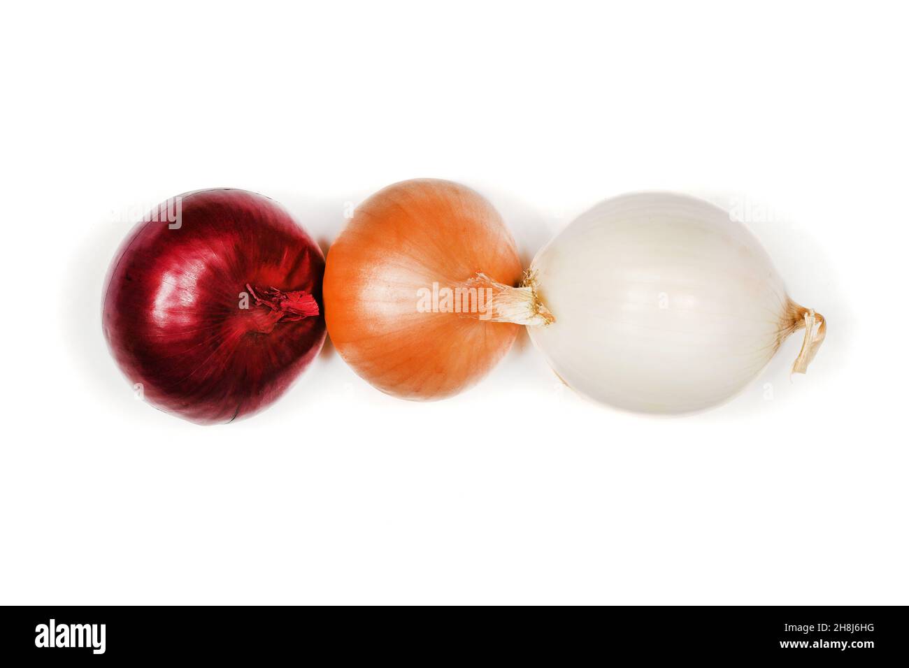 Three onion bulbs of different colors (red, yellow and white) isolated ...