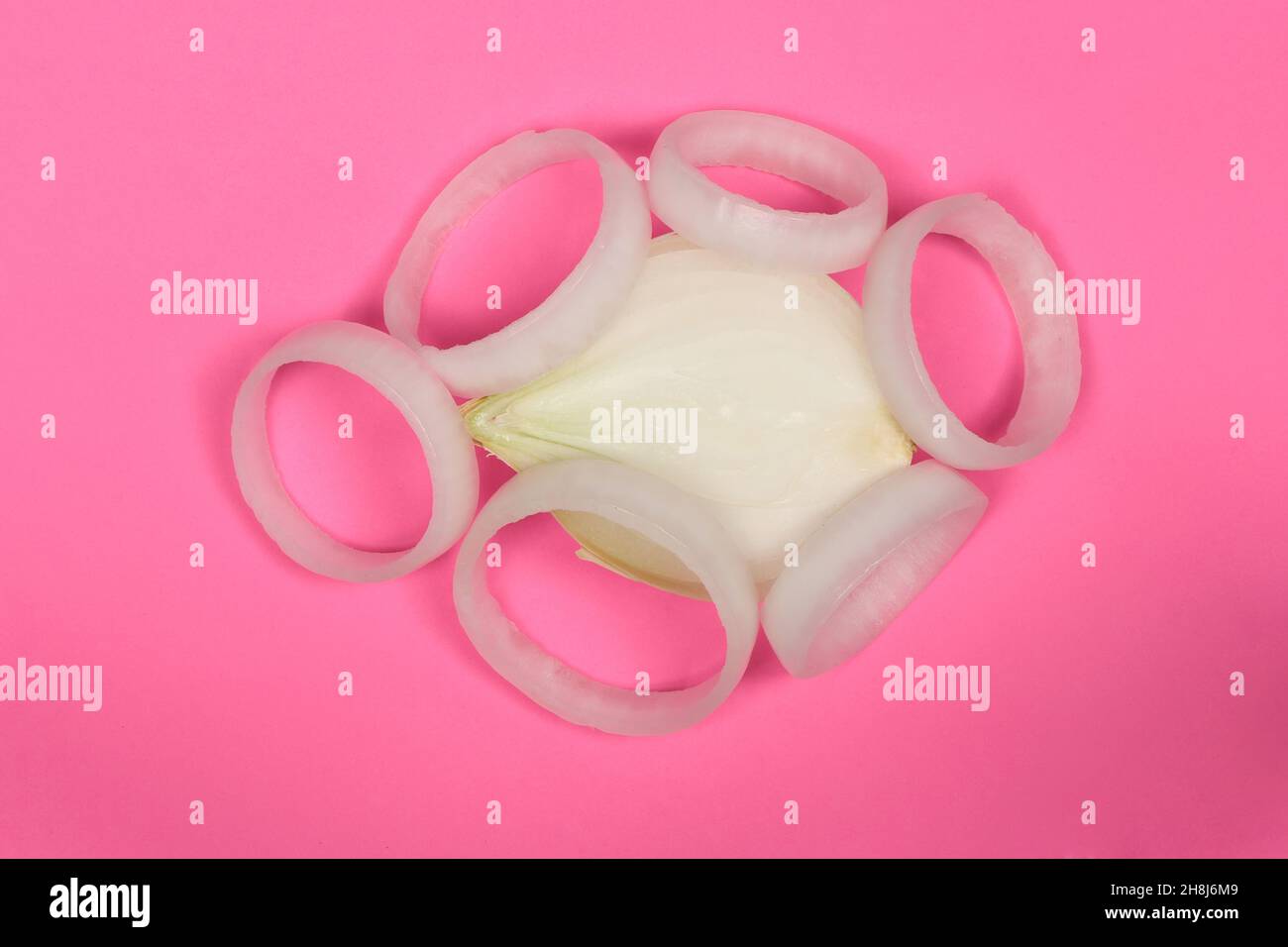 Sliced white onion rings isolated on pink background. High resolution ...