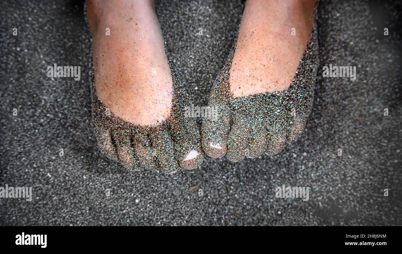 Feet of a person covered in sand Stock Photo - Alamy