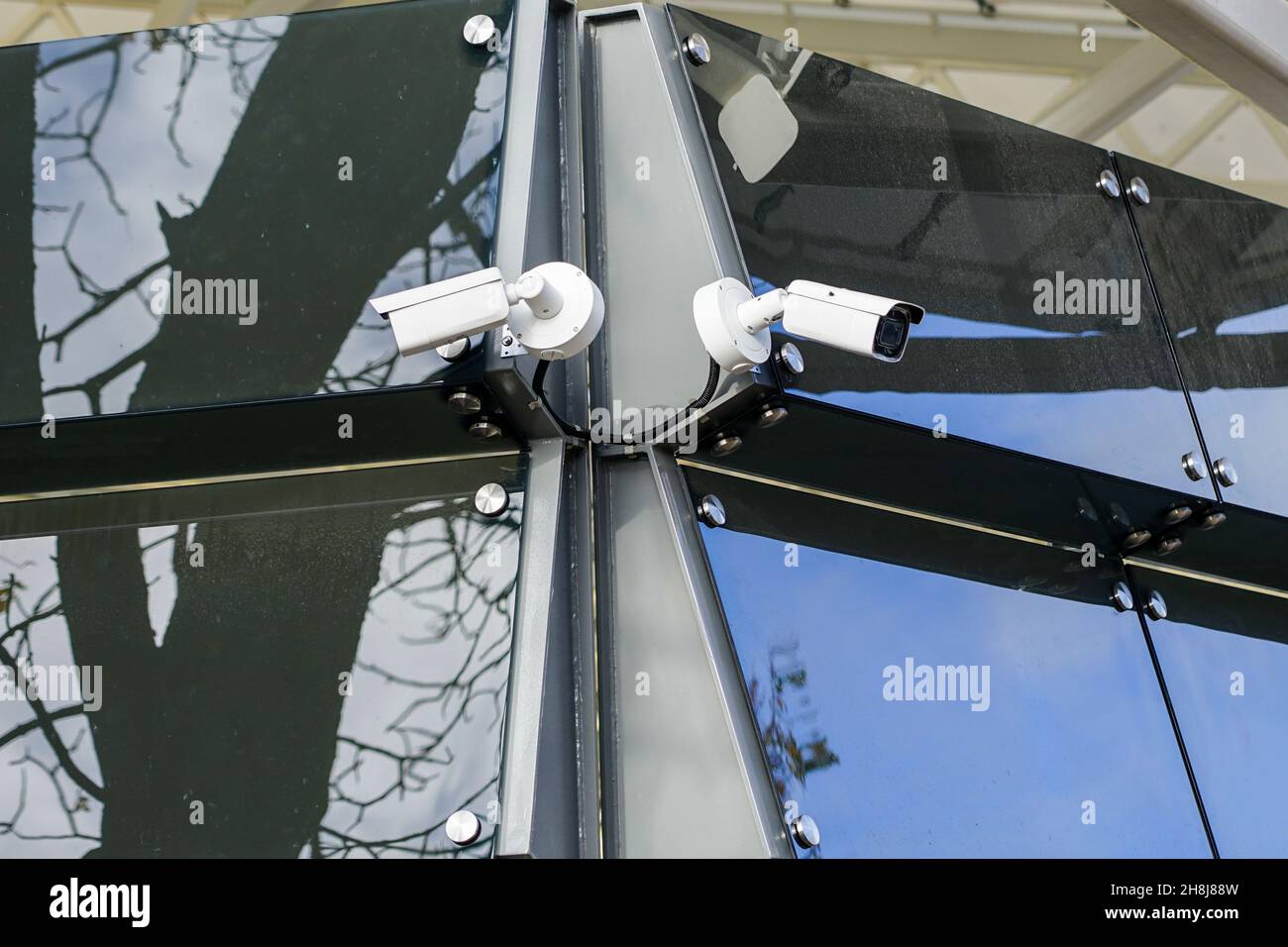 a fragment of the glass facade of a new modern house with two ...