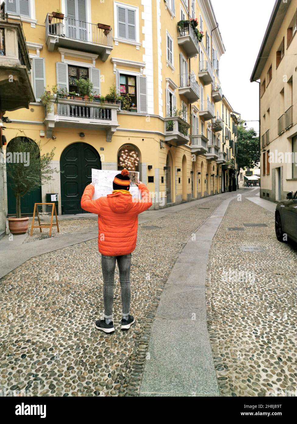 Rear view of a male looking at the map in the street Stock Photo - Alamy