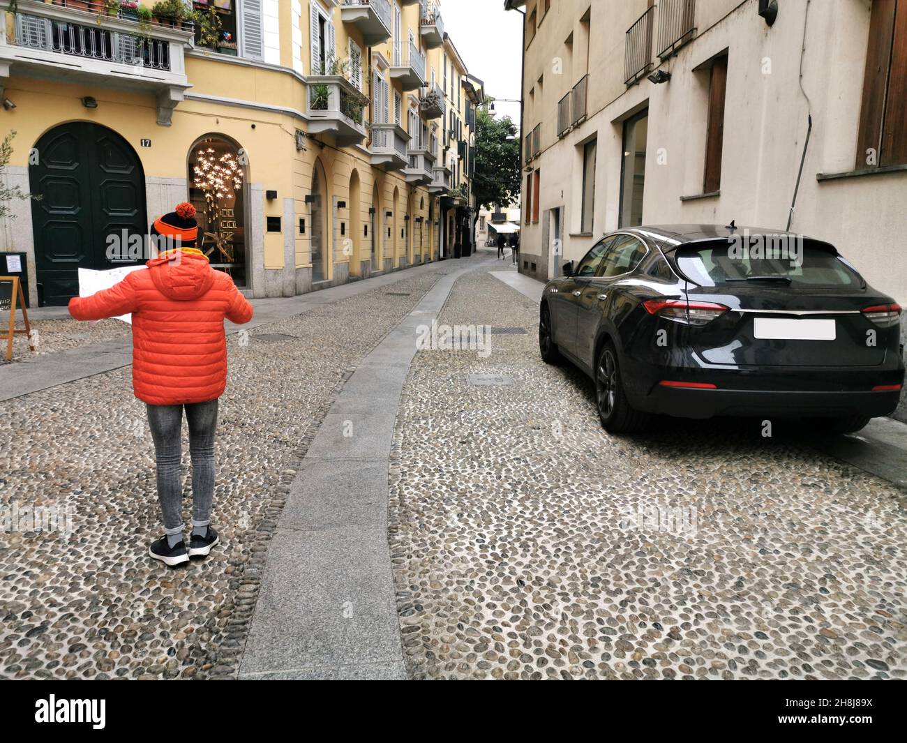 Rear view of a male looking at the map in the street Stock Photo - Alamy