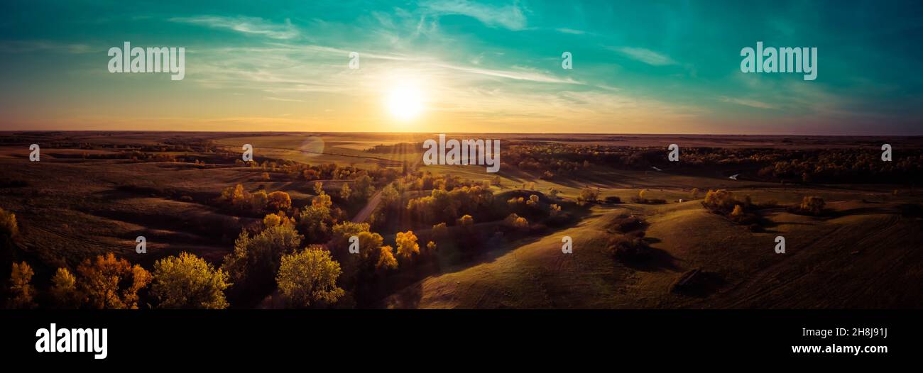 Aerial panorama of a sunset over the gentle rolling hills of the Great ...