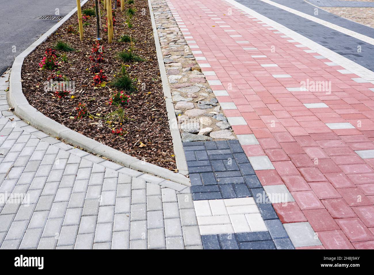 new modern colorful paved walkway and bicycle lane with cobblestones of ...