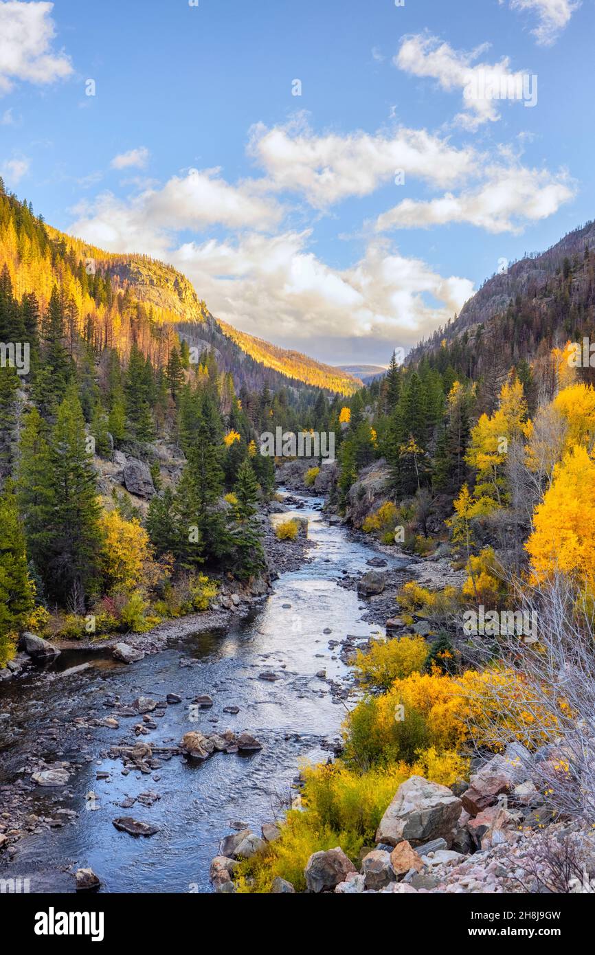 A beautiful scenic view of the colorado mountains with a river running ...