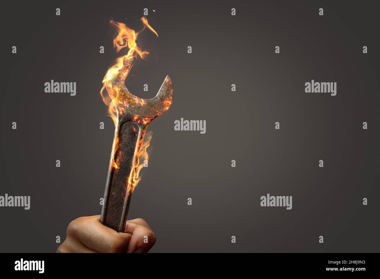 Wrench tool on fire with copy space Stock Photo - Alamy