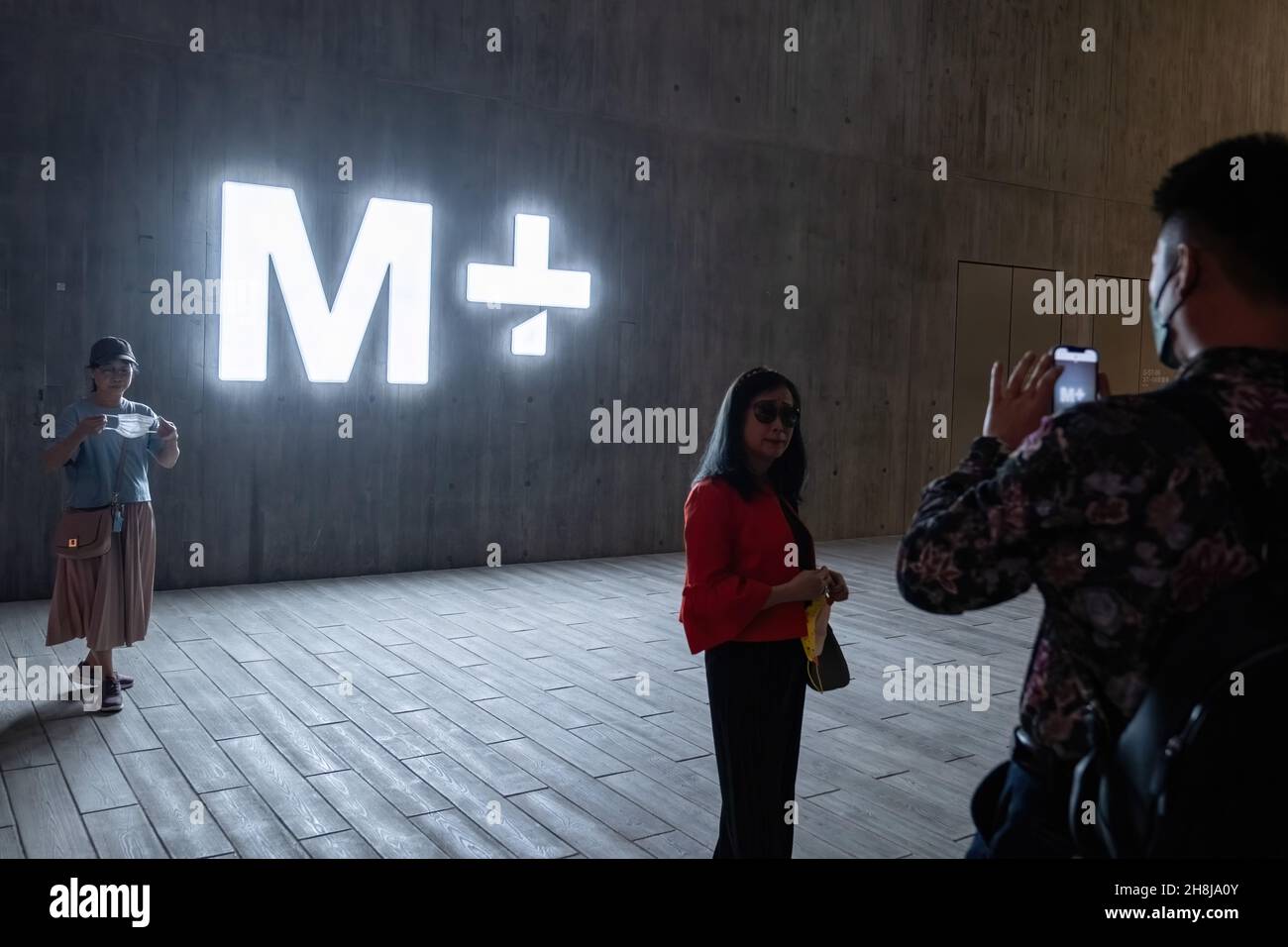 A visitor take pictures with the M+ logo background at the newly opened ...