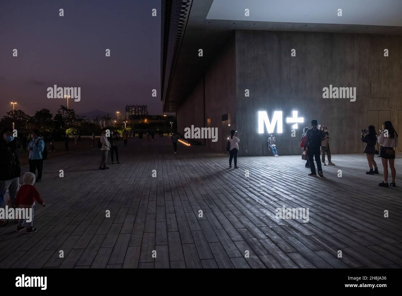 Visitors take pictures of the logo of the newly opened M+ museum. The ...