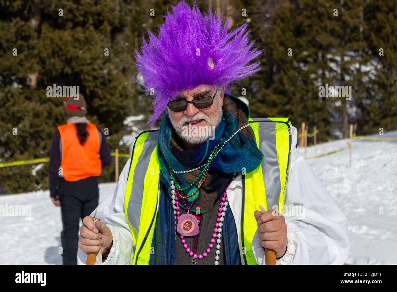 Local artist Bruce MacIntosh dressed in costume wearing bright purple ...