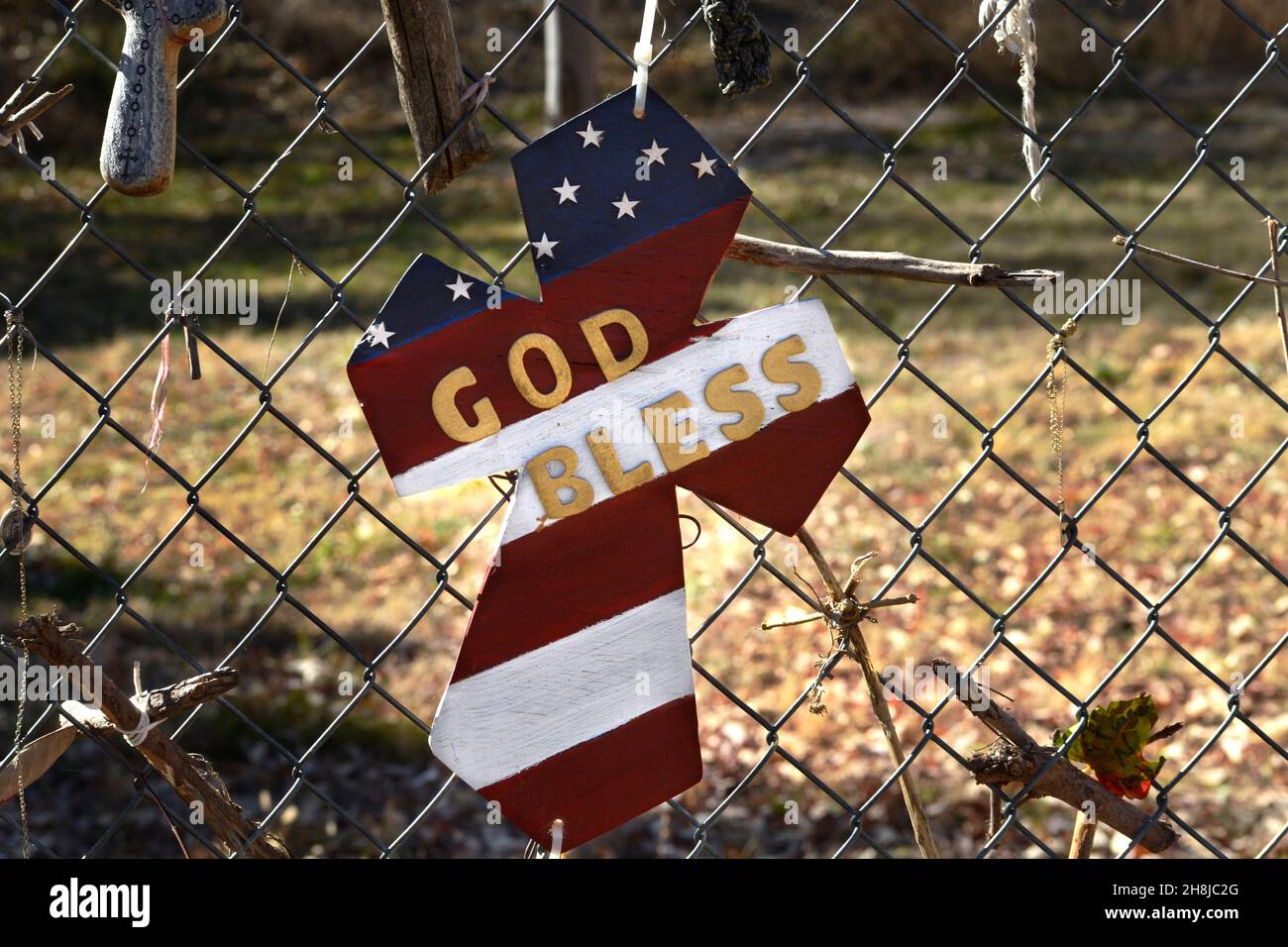 A handmade "God Bless" sign left by a visitor on a fence at the ...