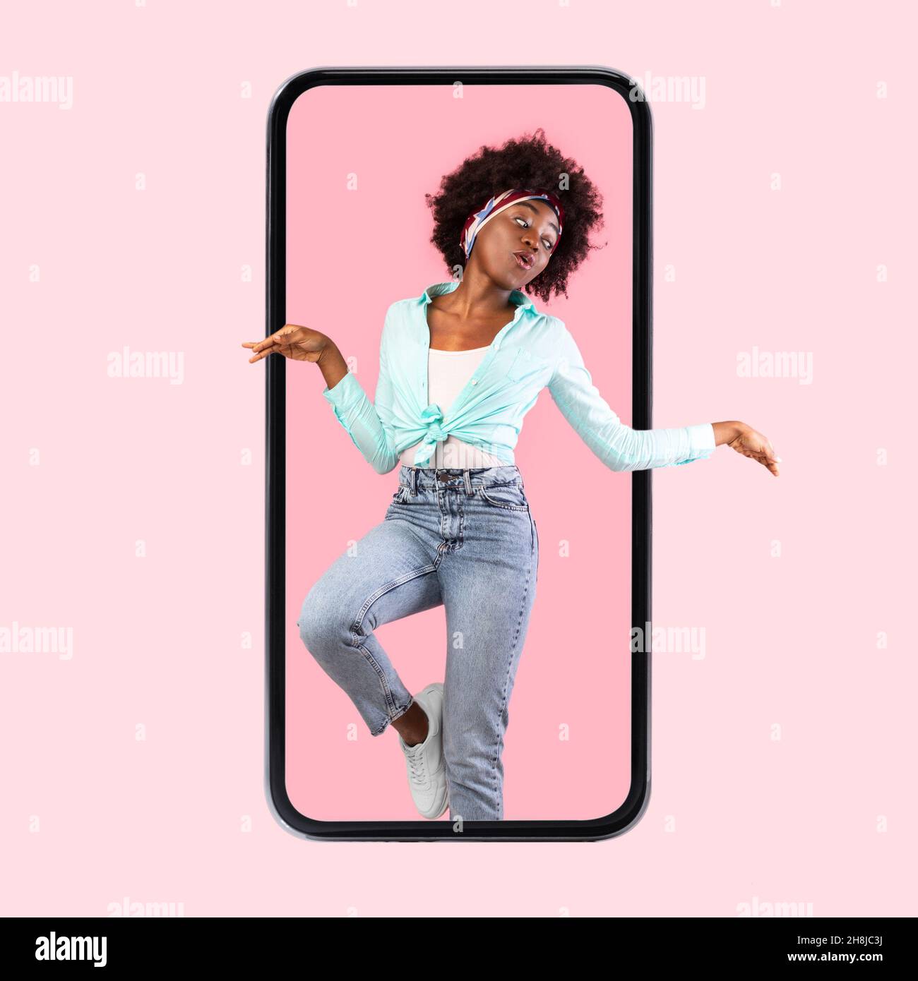 Happy woman coming out smartphone screen and jumping Stock Photo - Alamy