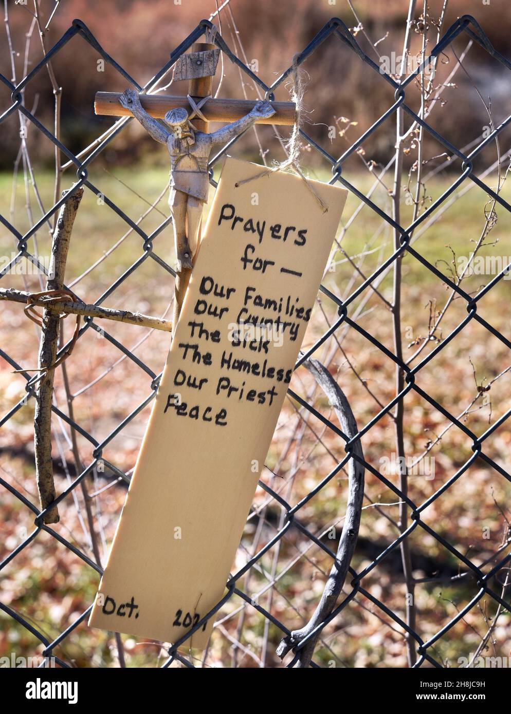 A handmade prayer sign left by a visitor on a fence at the historic ...
