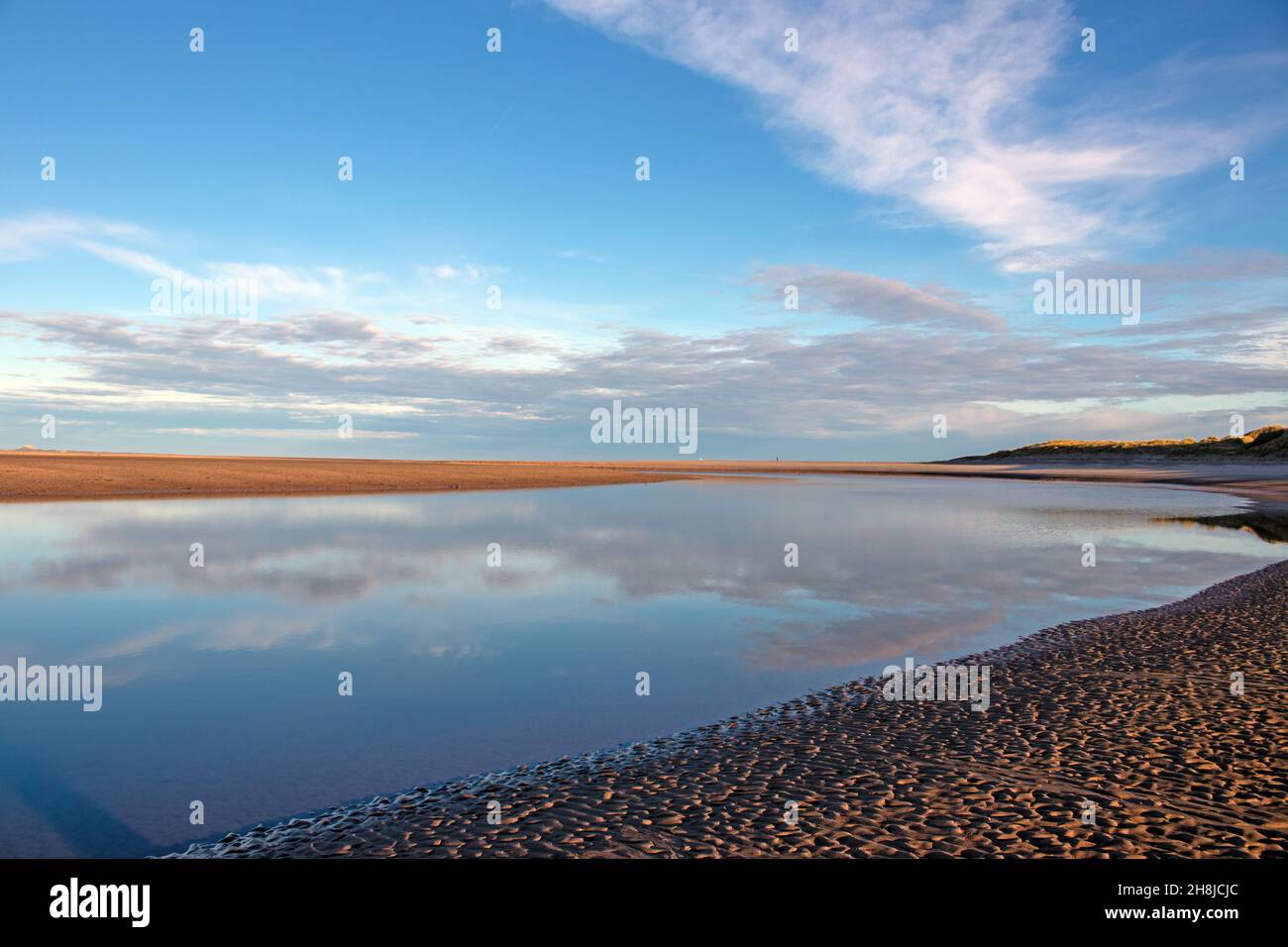 The beautiful Budle Bay, near Bamburgh, Northumberland, with early ...