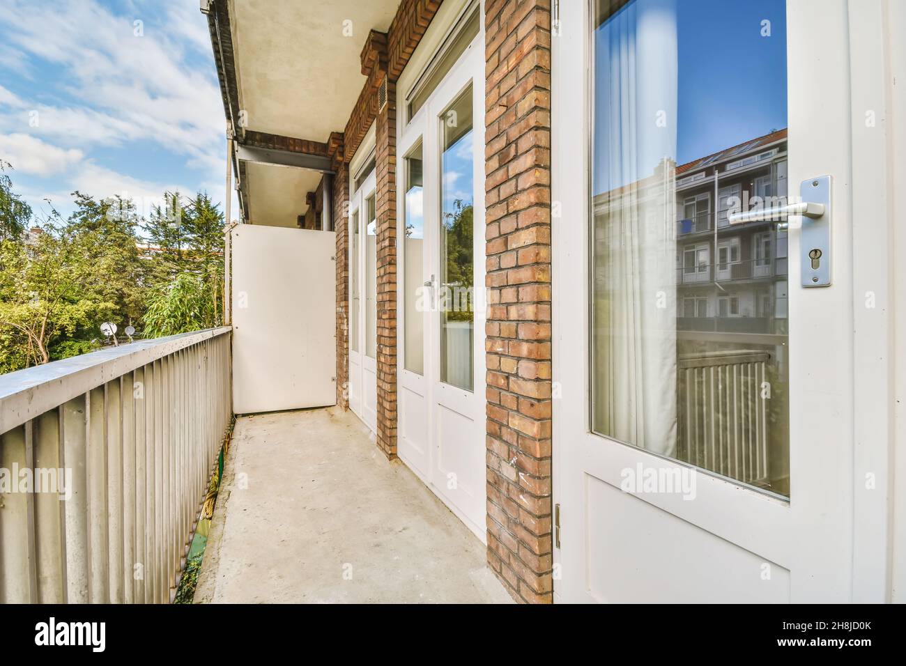 Attractive long narrow balcony with iron railings Stock Photo - Alamy