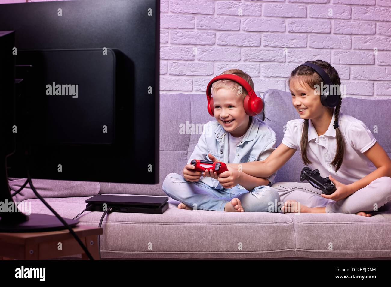 children playing video game with game console Stock Photo - Alamy