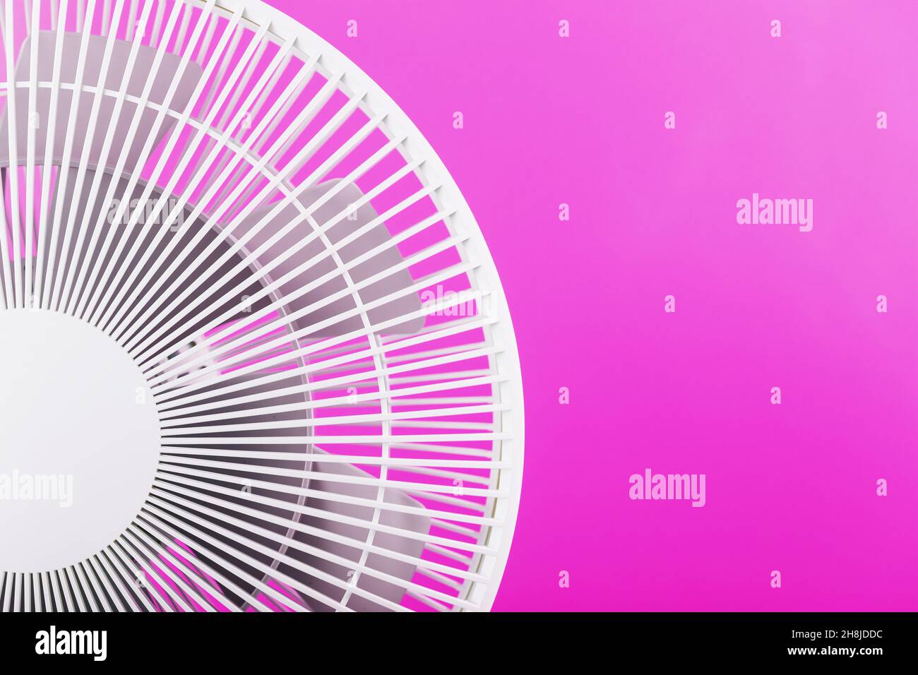 A high-tech white electric fan with a modern design for cooling the ...