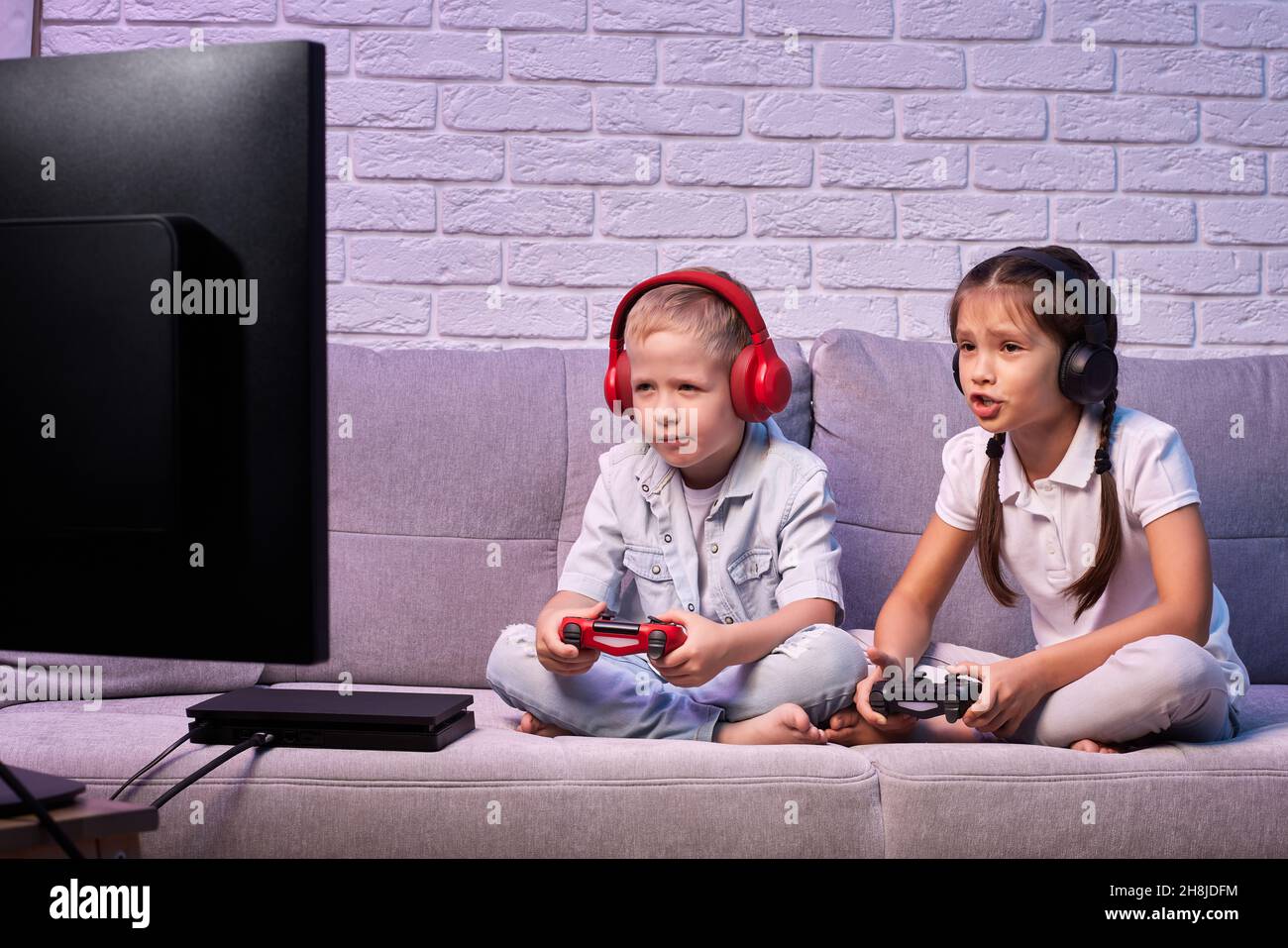 children playing video game with game console Stock Photo - Alamy