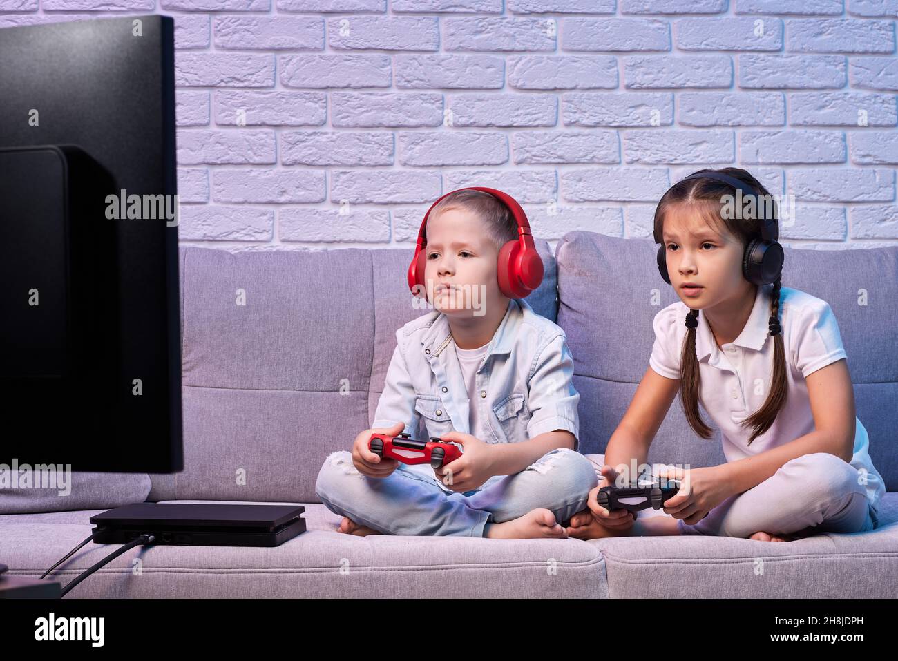 children playing video game with game console Stock Photo - Alamy
