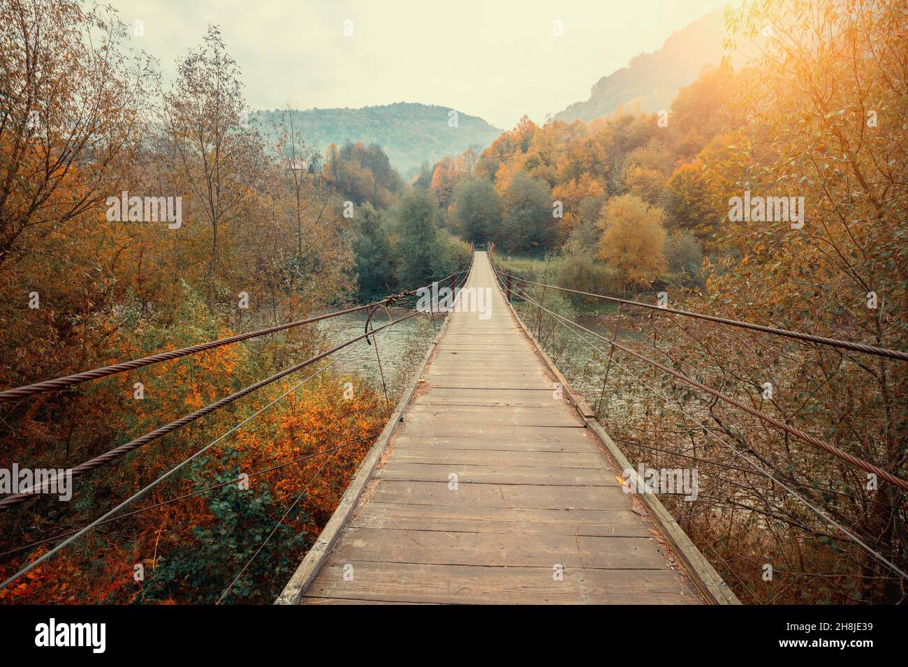 Wooden hanging rope bridge over mountain river Stock Photo - Alamy