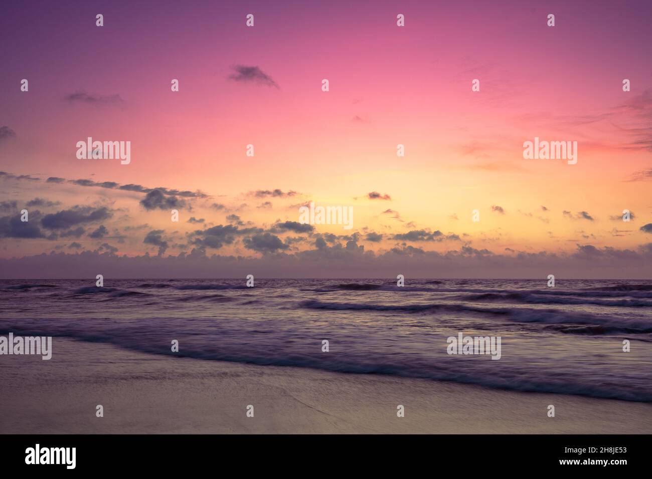 Seascape in the early morning. Sunrise on a sandy beach with beautiful ...