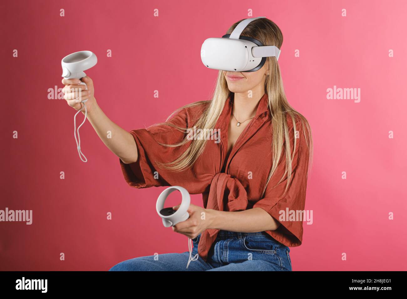 Blonde lady from Belgium playing a virtual reality game isolated on a ...