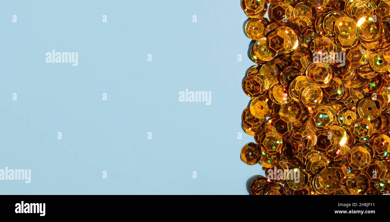 Shiny golden sequins on blue background.Festive banner with copy space ...
