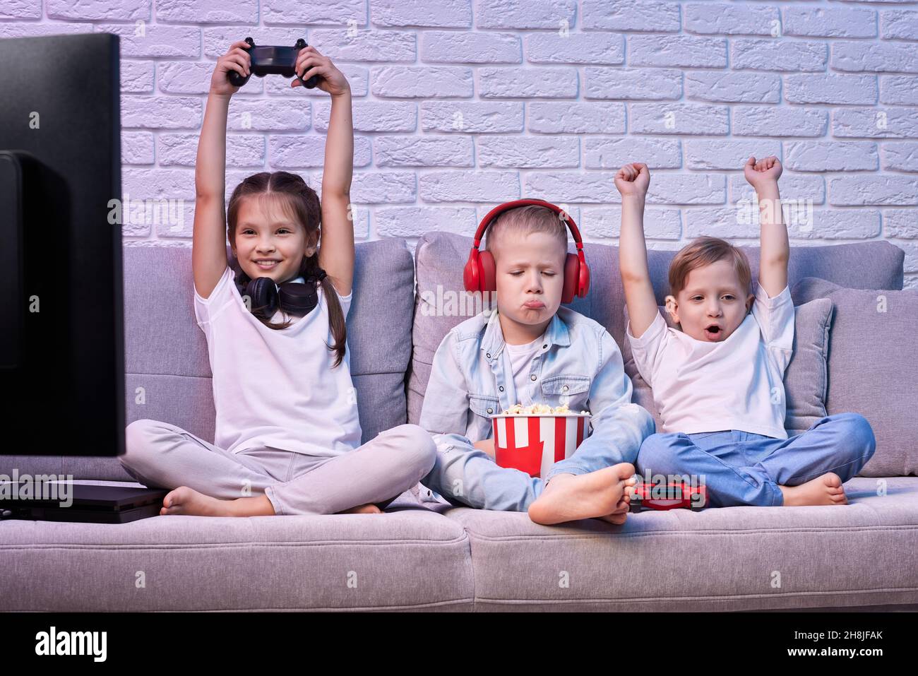 children playing video game with game console Stock Photo - Alamy