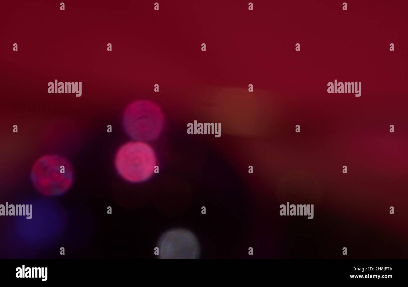 Red gradient background with colorful orbs in the lower-left corner of ...