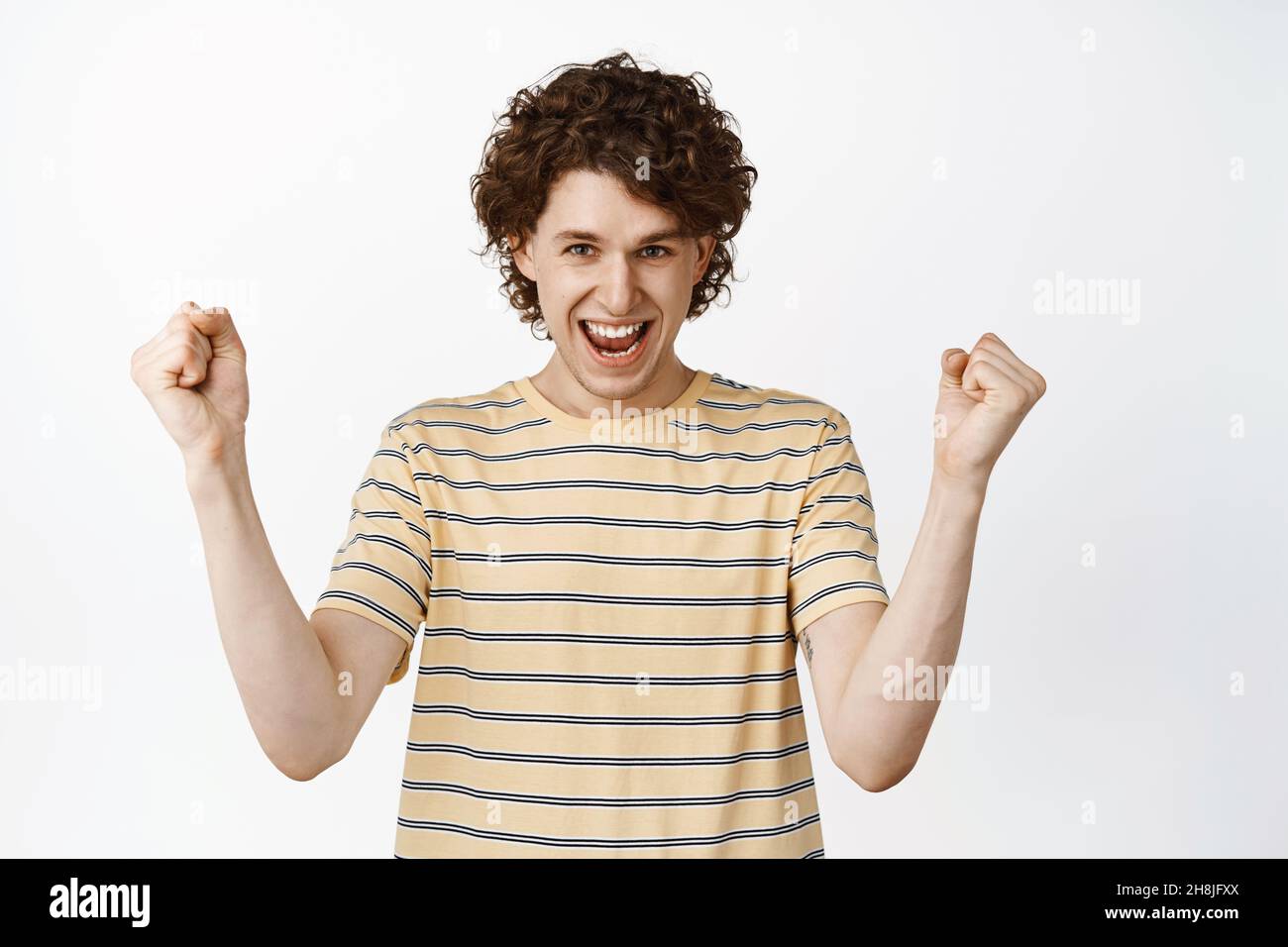 Enthusiastic male model showing winner pose, celebrating victory ...
