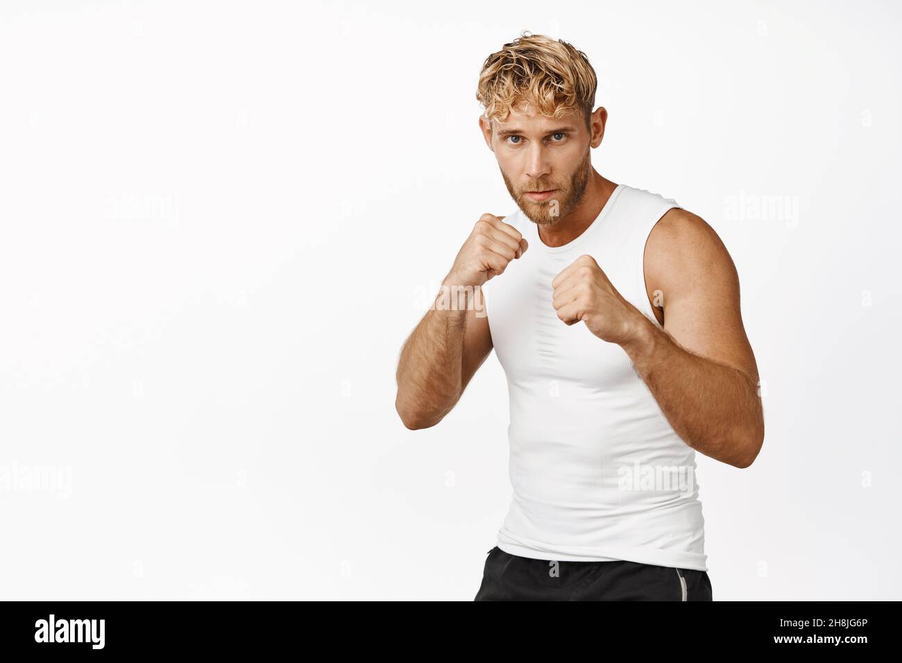 Handsome sportsman fighter practice punches, clench fists and fighting ...