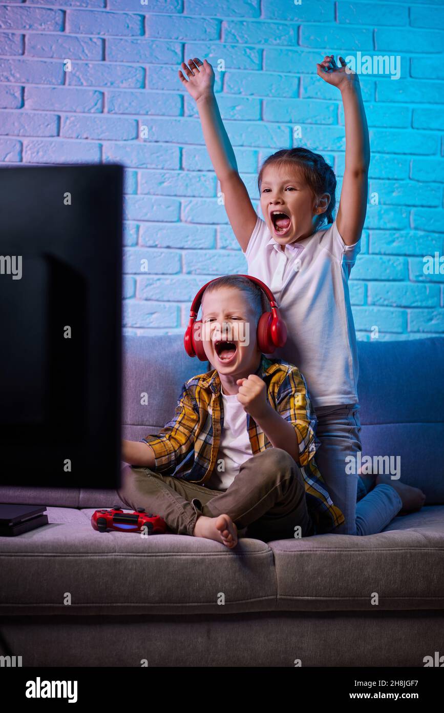 children playing video game with game console Stock Photo - Alamy